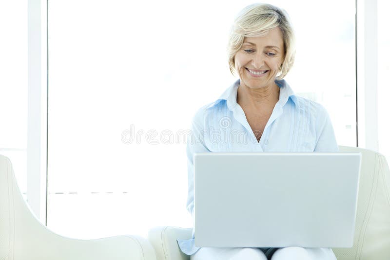 Mature woman using laptop stock image. Image of close - 50086755
