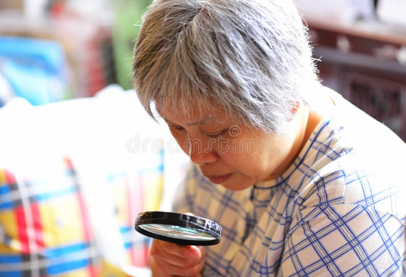 Senior Woman Using Magnifier Stock Image - Image of magnify, middleage ...
