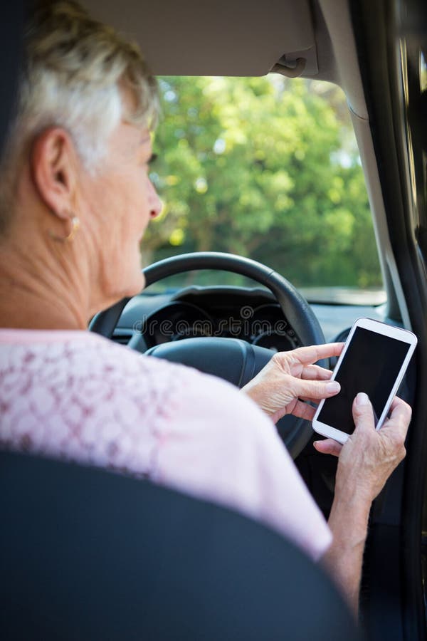 Senior Woman Using Mobile Phone while Driving a Car Stock Photo - Image ...