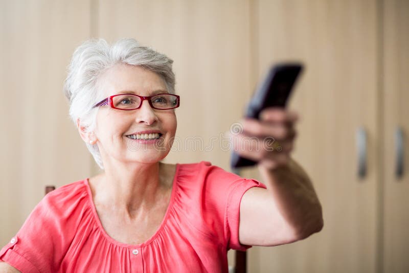 Senior Woman Using a Remote Control Stock Image - Image of patient ...