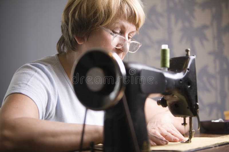 Senior Woman Using Sewing Machine Stock Image - Image of needlework ...
