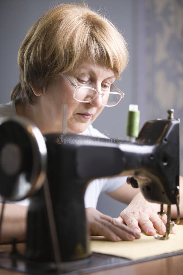 Senior Woman Using Sewing Machine Stock Photo - Image of retired ...