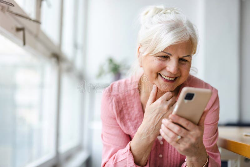 Senior Woman Using Smartphone Stock Photo - Image of real, loft: 274200096