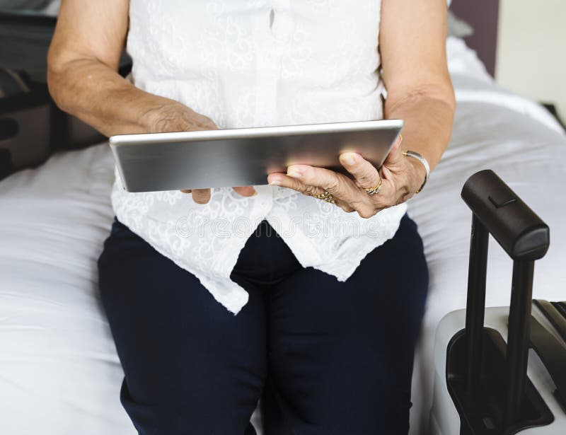 Senior Woman Using a Tablet on the Bed Stock Image - Image of retired ...