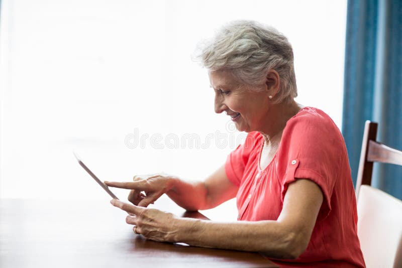 Senior Woman Using a Tablet Stock Image - Image of aged, senior: 77686955