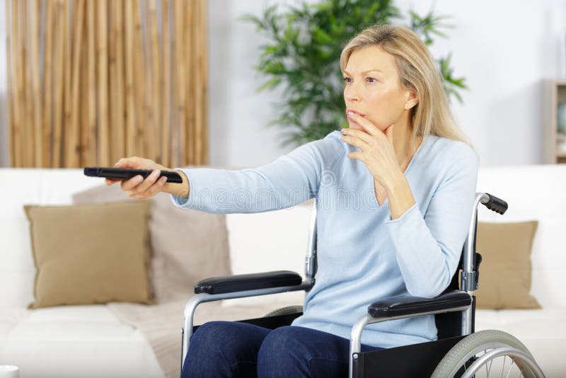 Senior Woman in Wheelchair with Remote Control at Home Stock Image ...