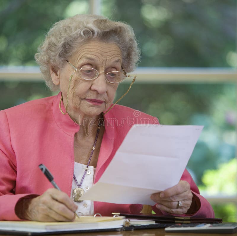 Senior Woman Writing a Check Paying Bill Stock Image - Image of ...
