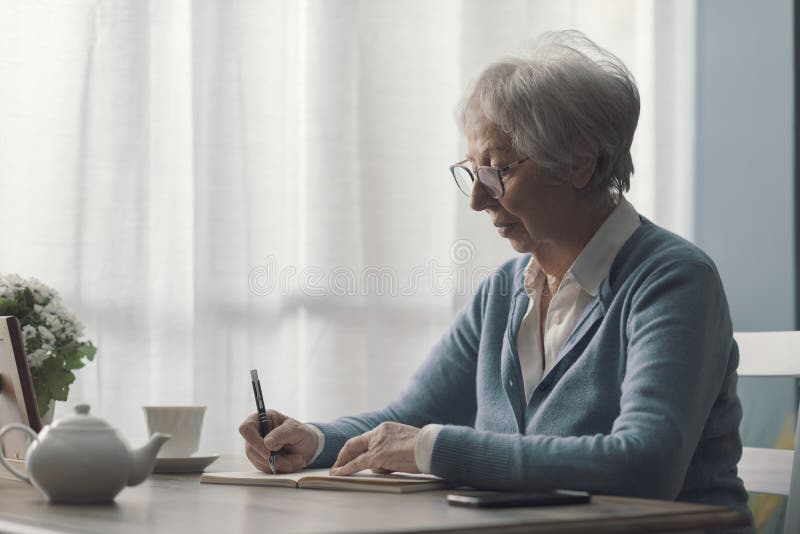 Senior Woman Writing on a Notebook Stock Image - Image of education ...