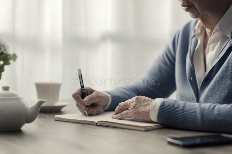 Senior Woman Writing on a Notebook Stock Image - Image of pages, break ...