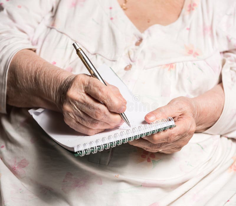 Senior woman writing notes stock photo. Image of older - 74269412