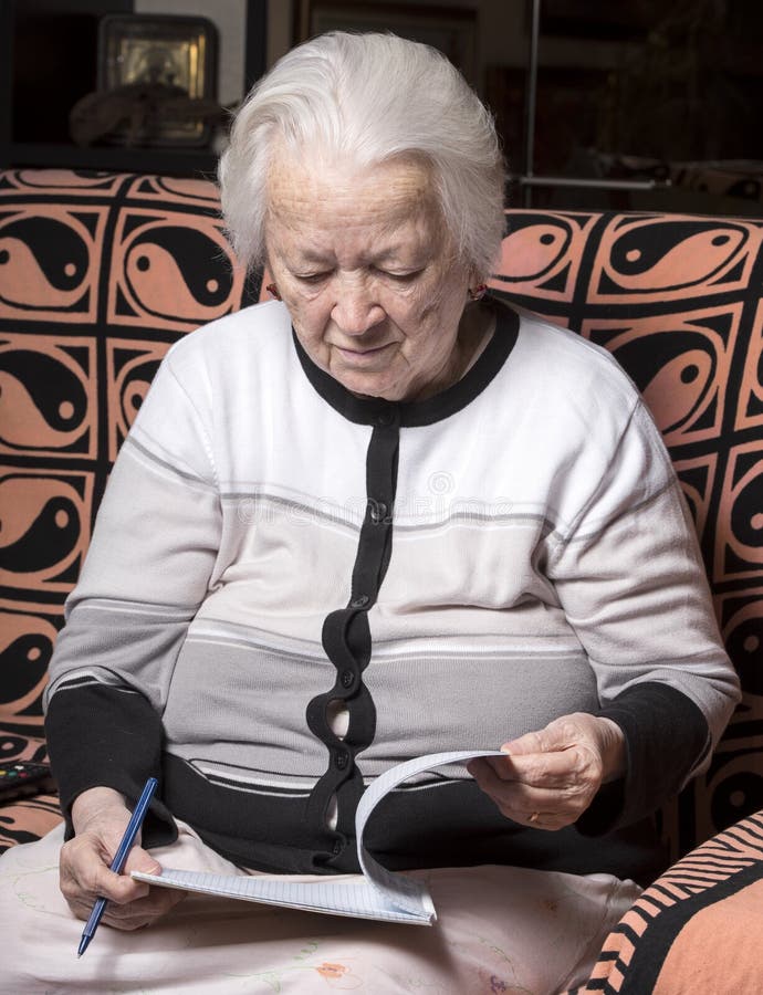Senior woman writing notes stock image. Image of alone - 49774899