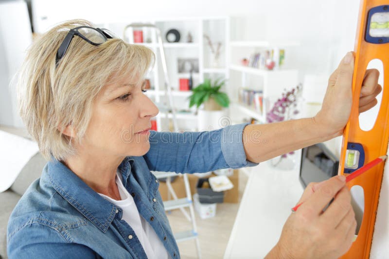 Senior Womanwith Leveling Tool at Home Stock Image - Image of toil ...