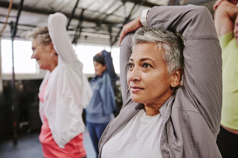 Senior Women Stretching Arms And Group For Health Fitness Or Wellness