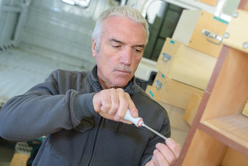 Senior Worker Assembling Cabinet Stock Image - Image of size ...