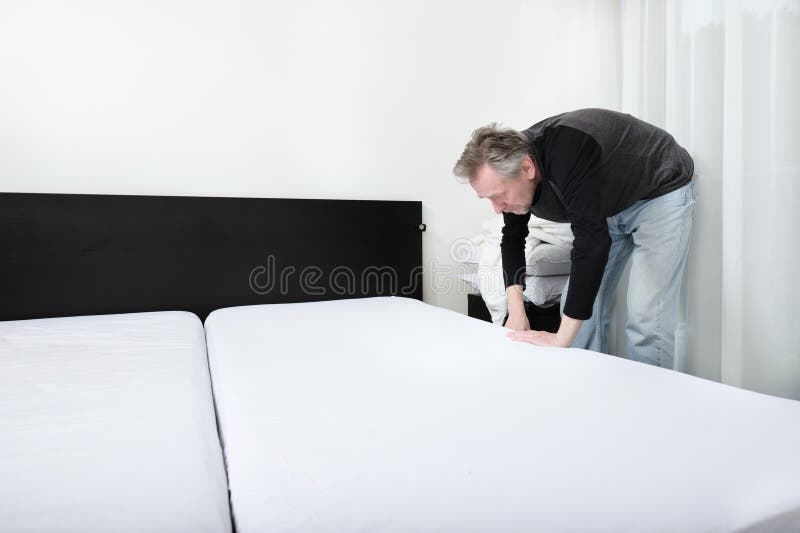 Senior Working on Bed Making in His Home Bedroom for Good Sleeping ...