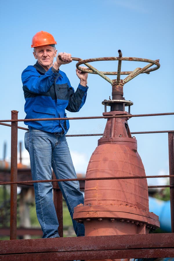 Senior Workman Turning Huge Valve Gate at Factory Stock Photo - Image ...