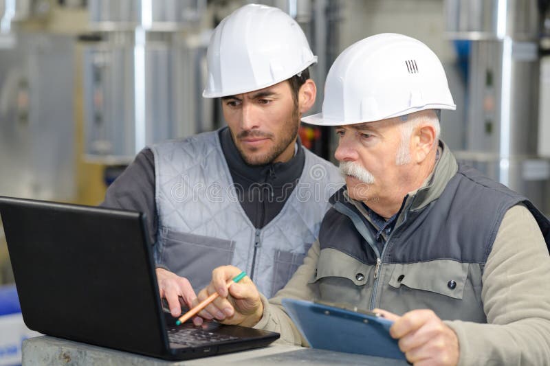 Senior and Young Engineer Working Together Stock Image - Image of busy ...