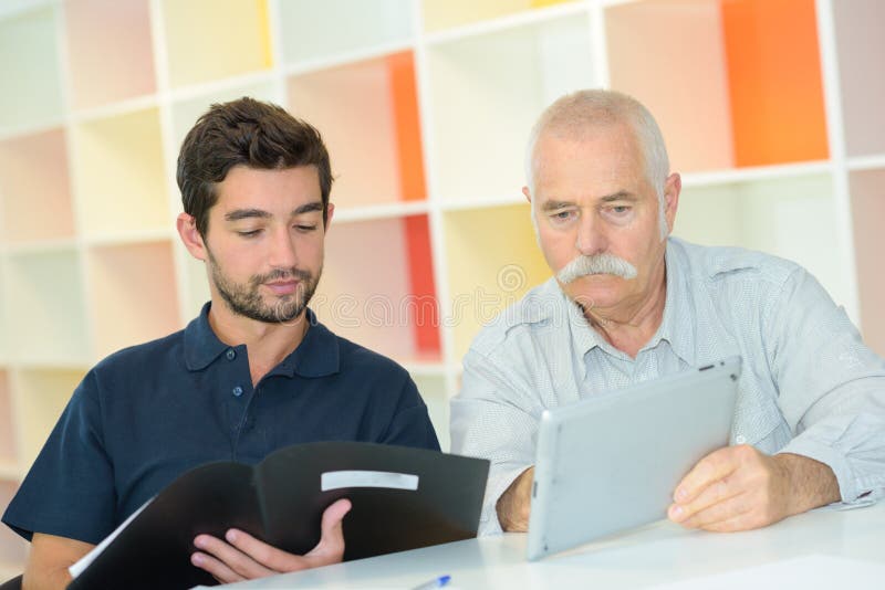 Senior and Young Working Together on Project Stock Photo - Image of ...