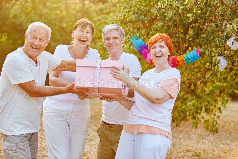 Seniors Laughing and Smiling with a Birthday Present Stock Photo ...
