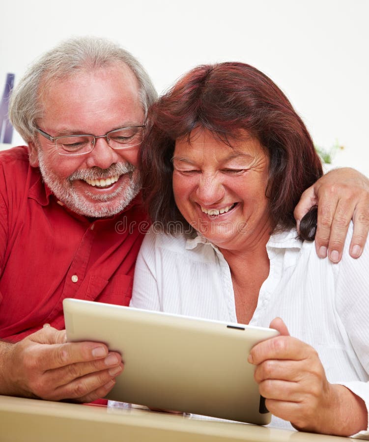 Seniors Look at Tablet Computers Together Stock Image - Image of hold ...