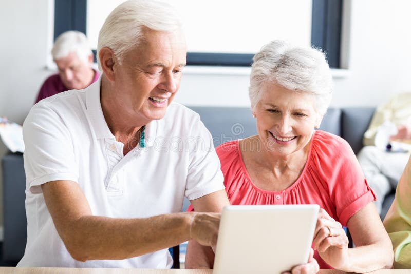 Seniors using a tablet stock image. Image of leisure - 77686537