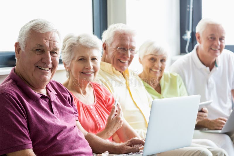 Seniors using technology stock photo. Image of couch - 77686522