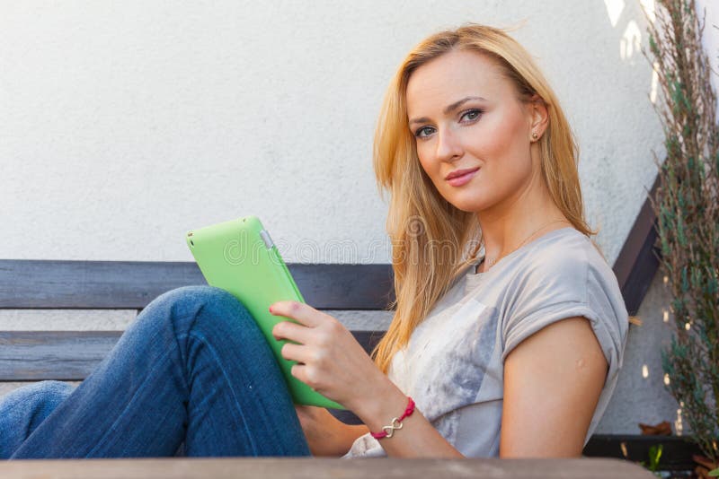 Sensual Happy Blonde Woman Sitting On Wooden Bench She Is Using Mobile