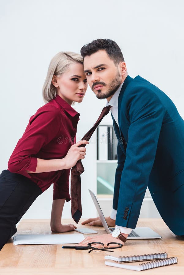Sensual Young Business Colleagues Flirting and Looking at Camera Stock ... Sensual Young Business Colleagues Flirting and Looking at Camera Stock ...
