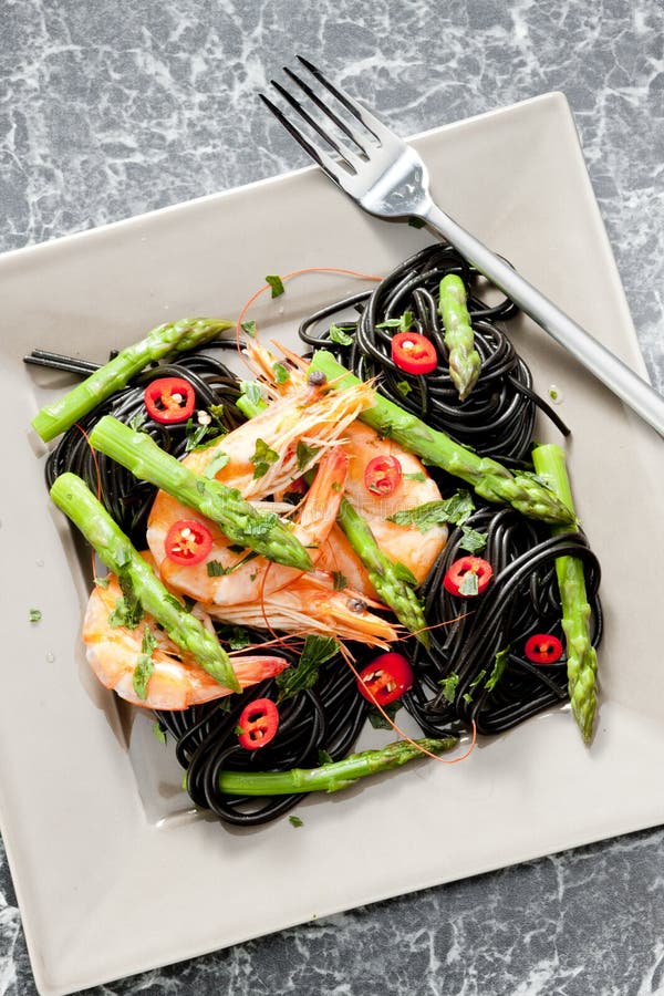Sepia Spaghetti with Prawns, Asparagus and Chilli Stock Photo - Image ...
