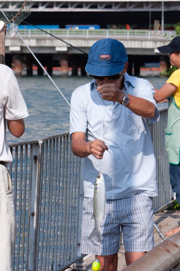 1 Sept 2007 the Old Man Releasing Fish while Standing at Shore ...