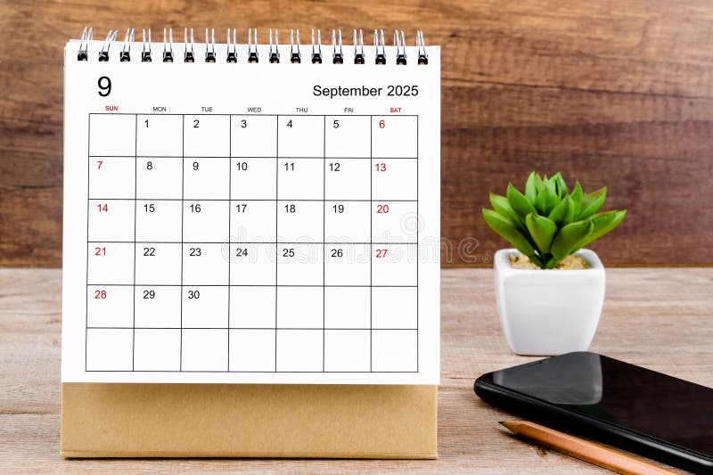 September 2025 Desk Calendar on Wooden Table with Black Smartphone ...