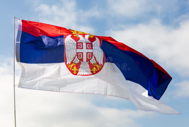 Serbian Flag Flying Against Blue Sky Stock Photo - Image of fluttering ...