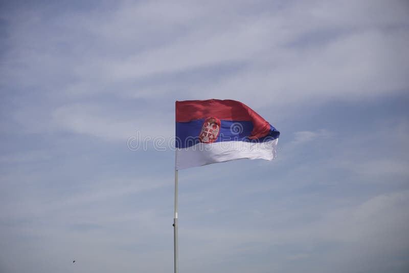Serbian Flag Waving Against a Cloudy Blue Sky Stock Photo - Image of ...