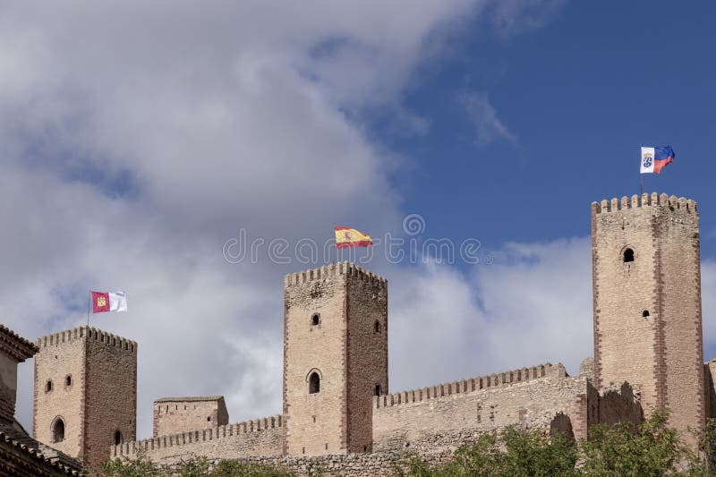 A Serene, Ancient Stone Castle with Distinct Flags Atop Towers Under a ...