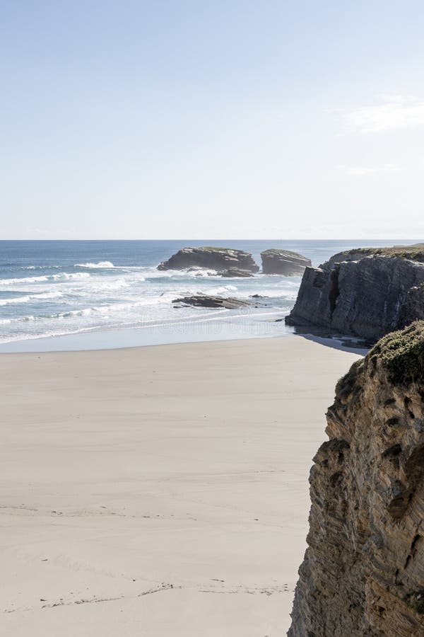 A Serene Beach with Cliffs, Ocean Waves, Clear Sky, and an Isolated ...