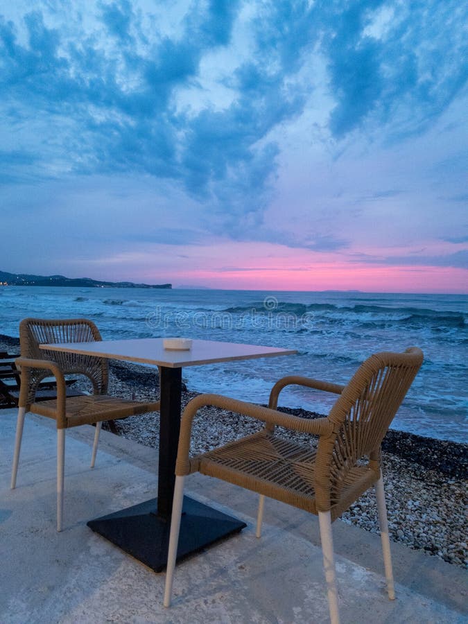 Seaside Table with Two Chairs Presents a Serene Beachside Scenery ...