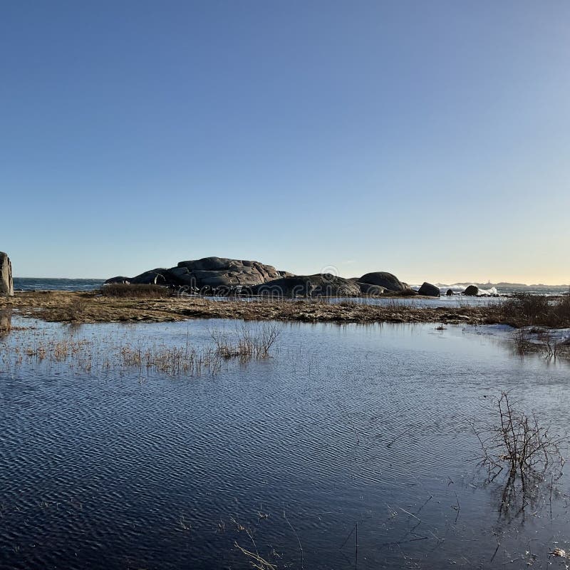 Serene Body of Water with Distant Rocks Stock Photo - Image of serene ...
