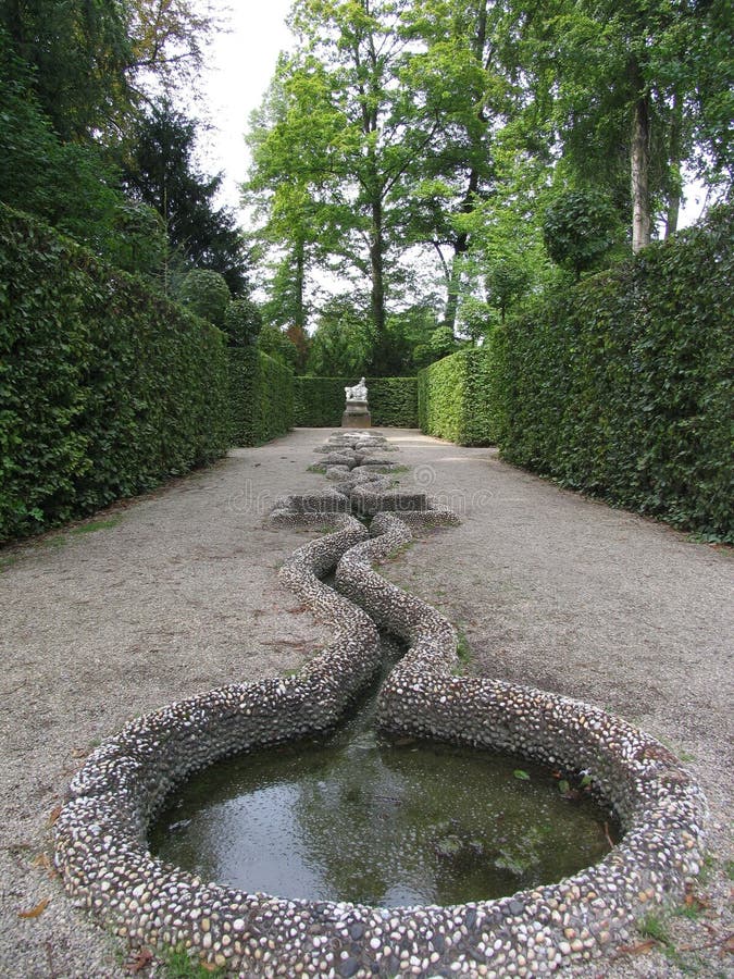 Serene Garden Path with Pebble Water Feature Stock Photo - Image of ...