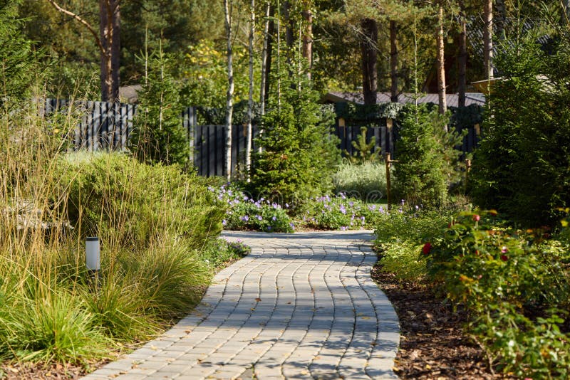 A Serene Garden Pathway that is Beautifully Surrounded by Lush, Verdant ...