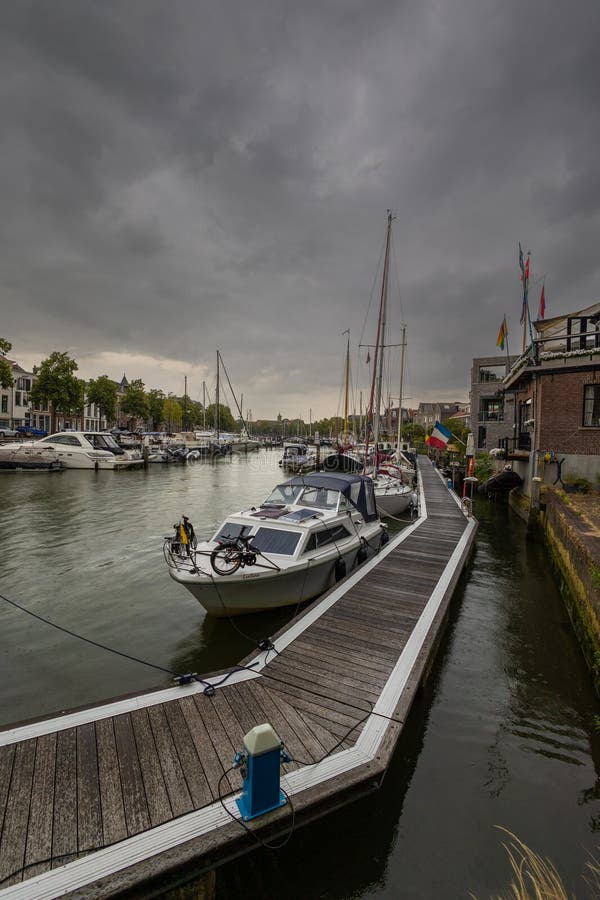 Serene Harbor with Moored Boats Under a Dramatic Cloudy Sky. Quaint ...