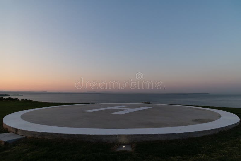 A Serene Image of a Helipad Overlooking the Sea at Sunset, with a Clear ...