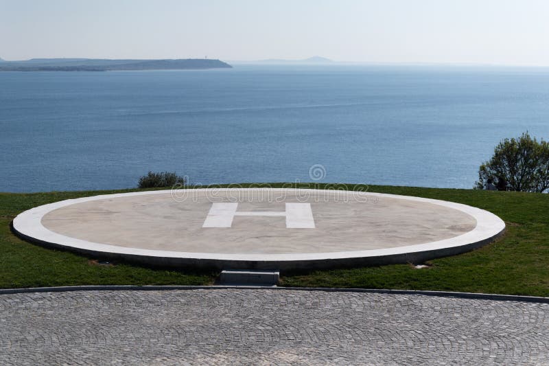 A Serene Image of a Helipad Overlooking the Sea at Sunset, with a Clear ...
