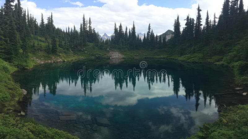 The Lake Reflects the Sky , Surrounded by Trees and Mountains ...