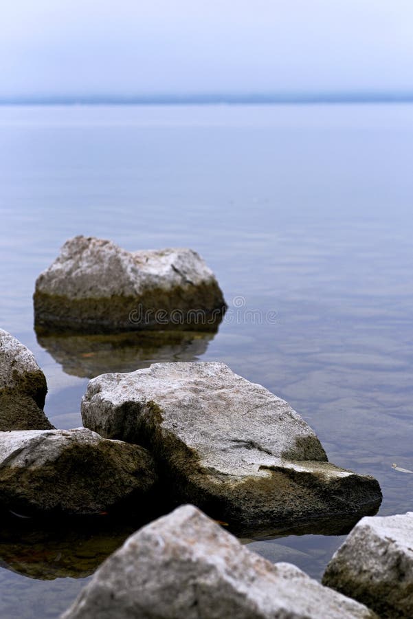 Serene Lakeside Haven: Stones by the Shore Stock Photo - Image of ...