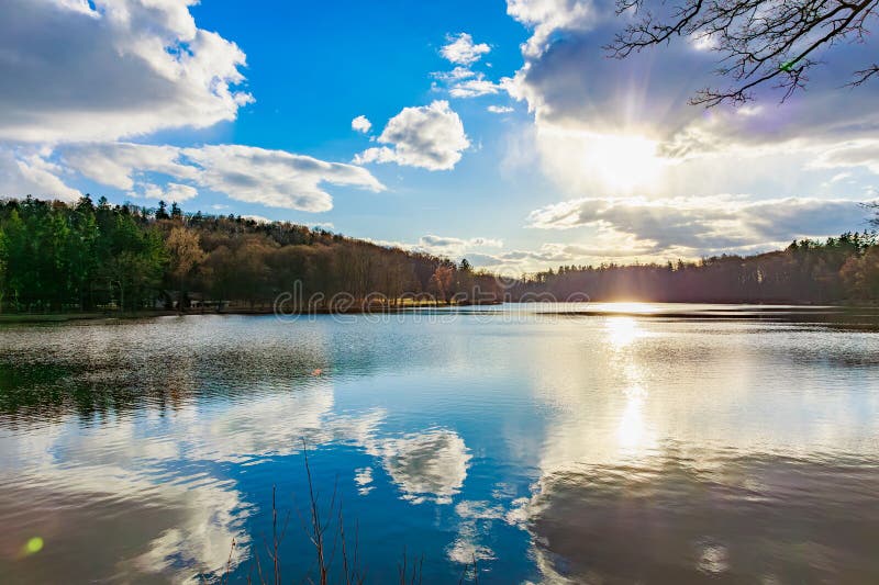 Serene Lakeside View with Sunlit Sky and Tranquil Waters Stock Image ...