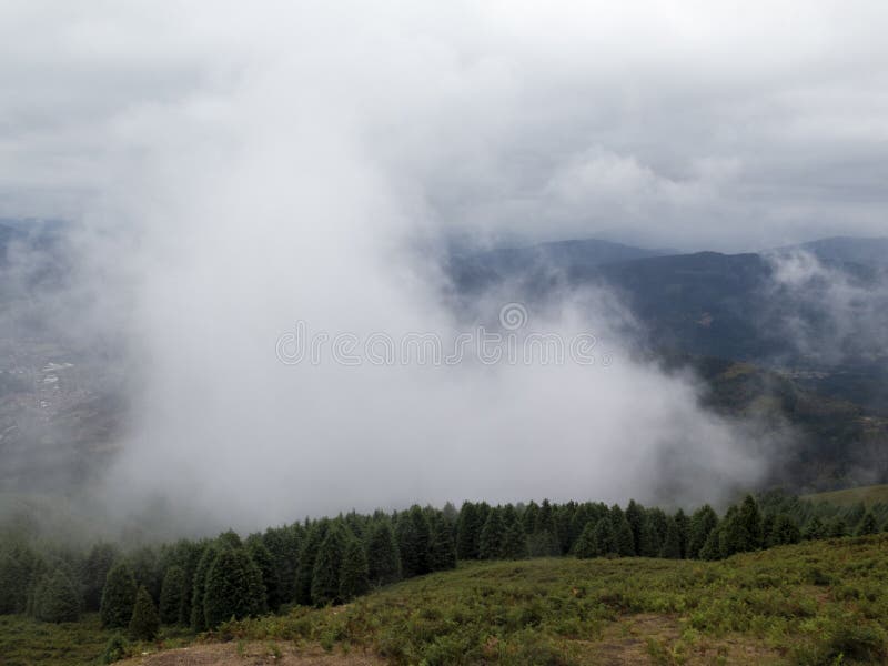 A Serene, Misty Landscape with Green, Rolling Hills and Distant ...