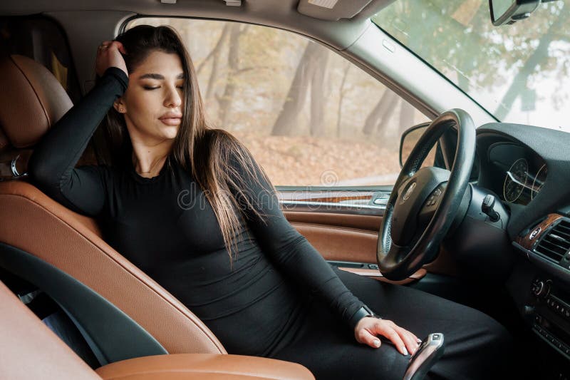 A Serene Moment: a Woman in Relaxed Elegance Inside a Luxury Car Stock ...