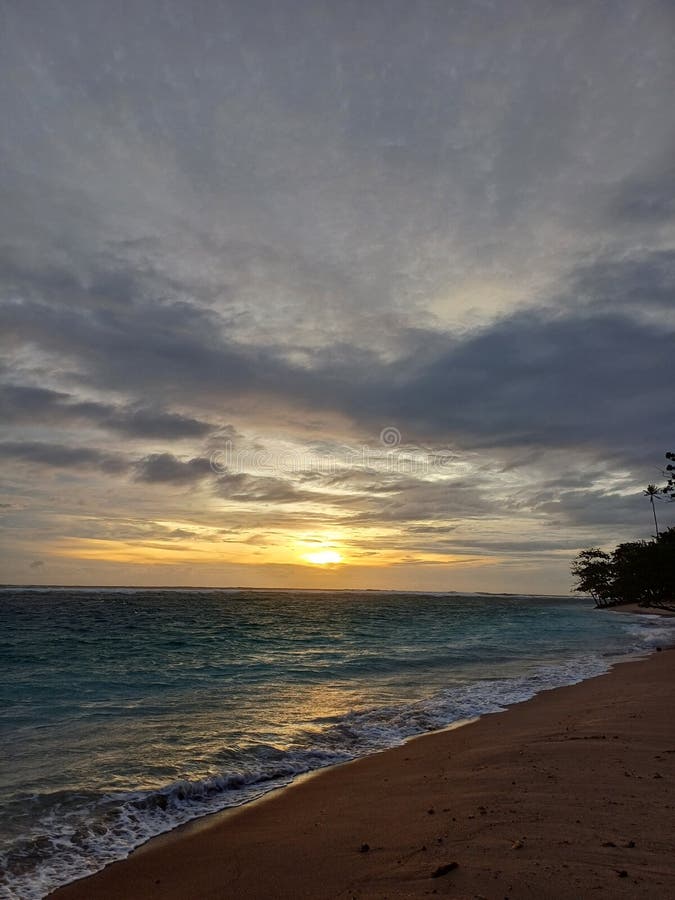 Serene Ocean Sunrise with Soft Light Breaking through the Clouds. Calm ...