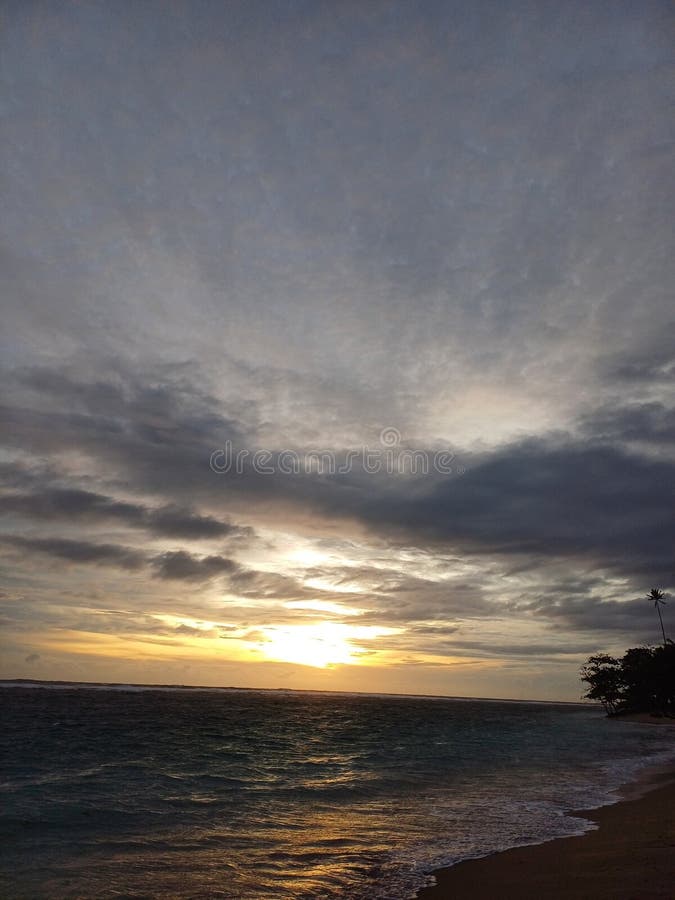 Serene Ocean Sunrise with Soft Light Breaking through the Clouds. Calm ...