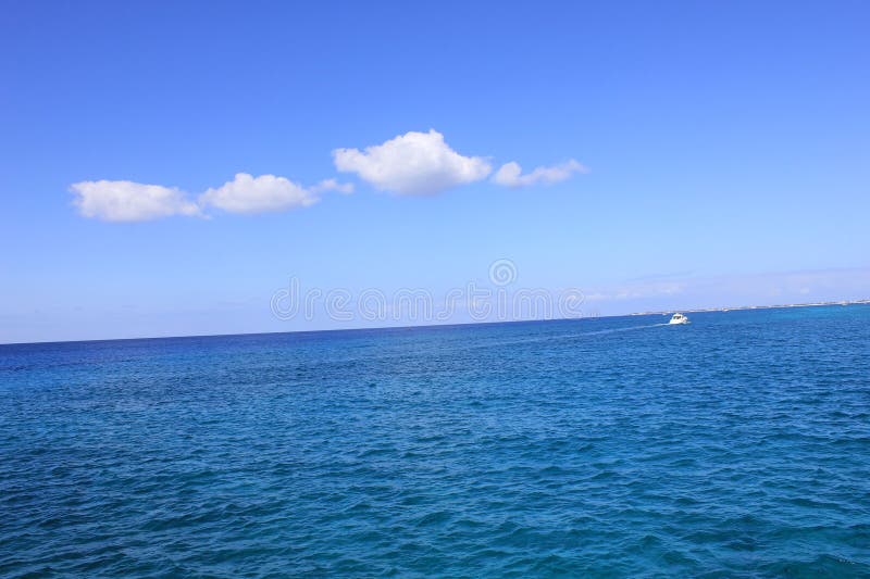 Serene Ocean View with a Boat and Blue Sky. Stock Image - Image of ...